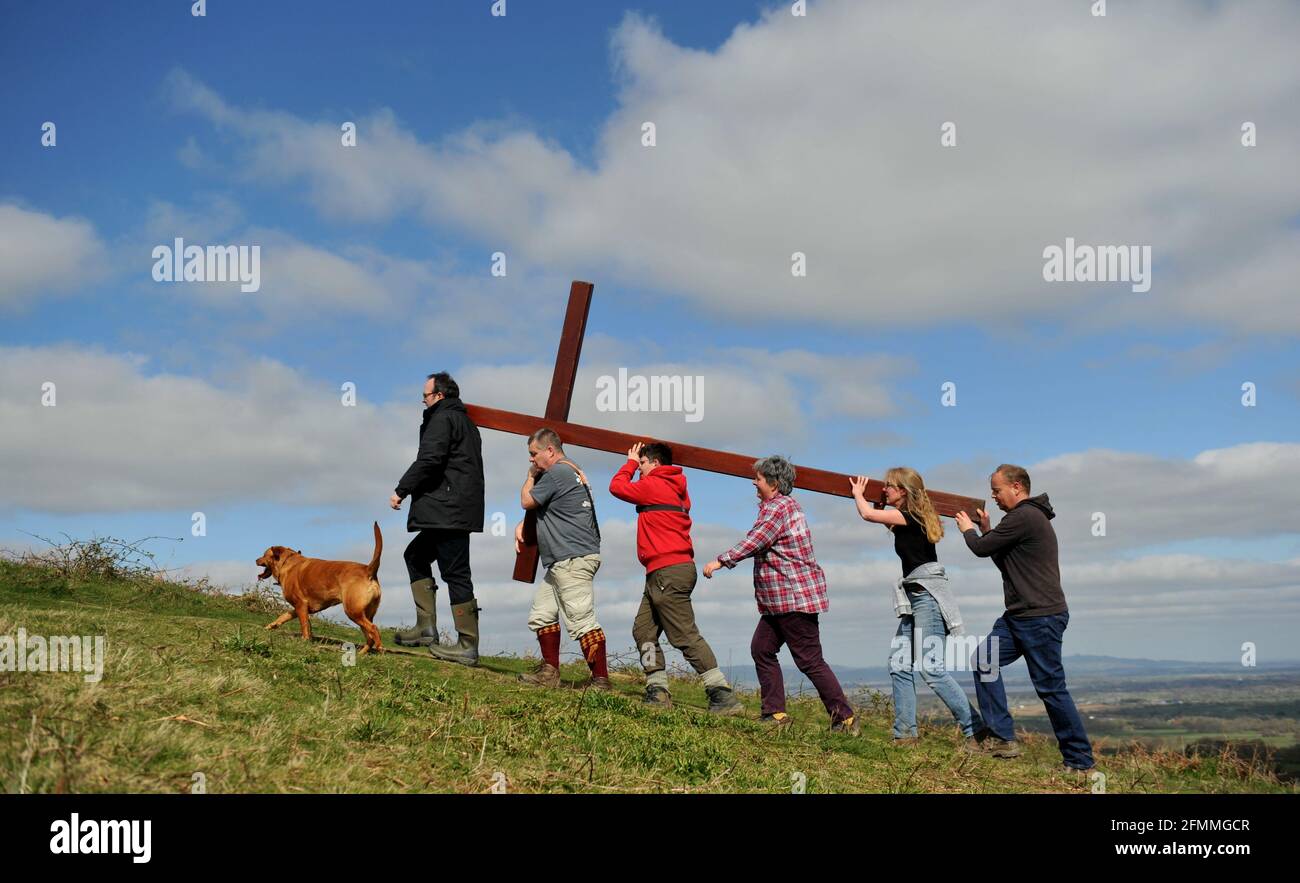 Carrying a wooden cross up Cam Peak on Good Friday before Easter Sunday ...