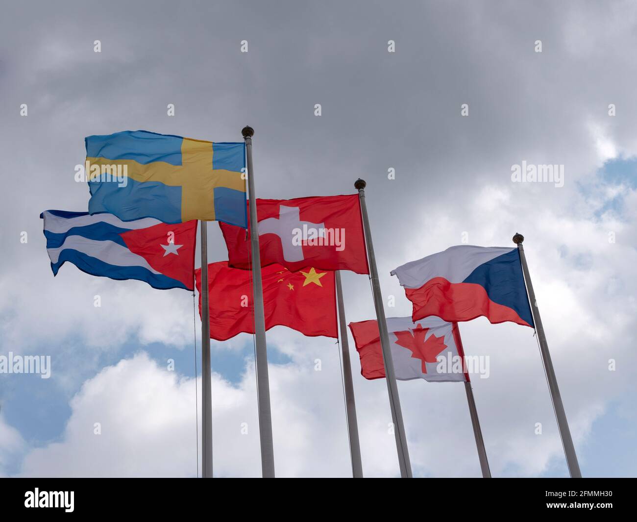 Various national flags countries under a blue sky Stock Photo - Alamy