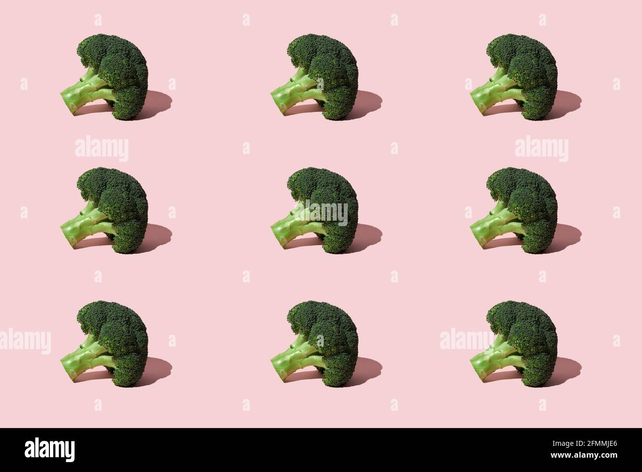 Green Broccoli head on pink background Stock Photo - Alamy