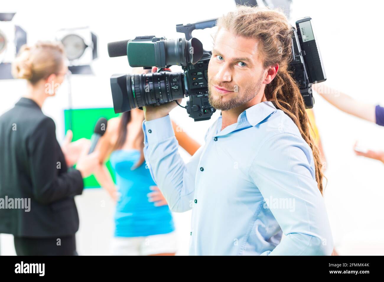 Camera man filming on set for video production an interview situation ...