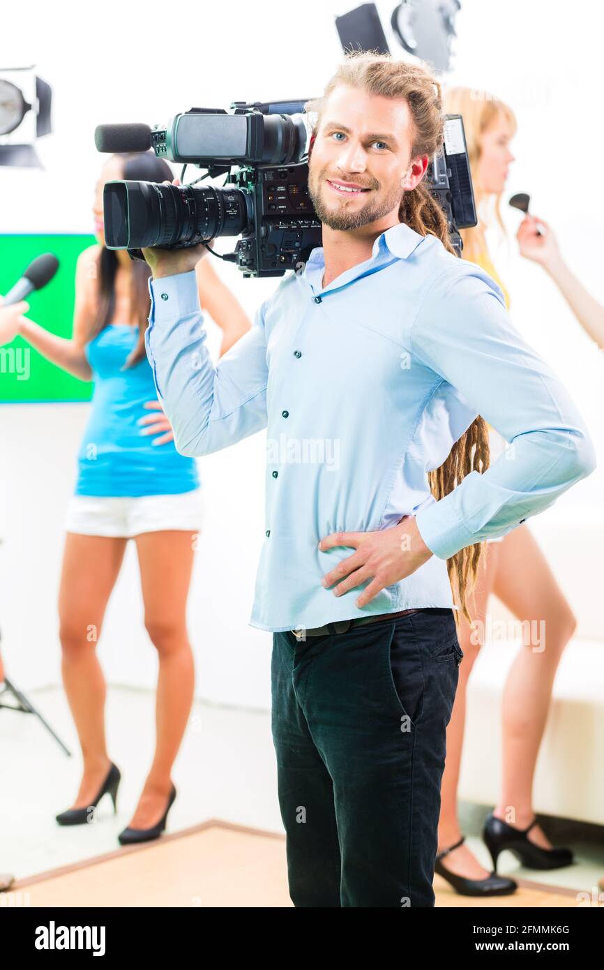 Camera man filming on set for video production an interview situation ...