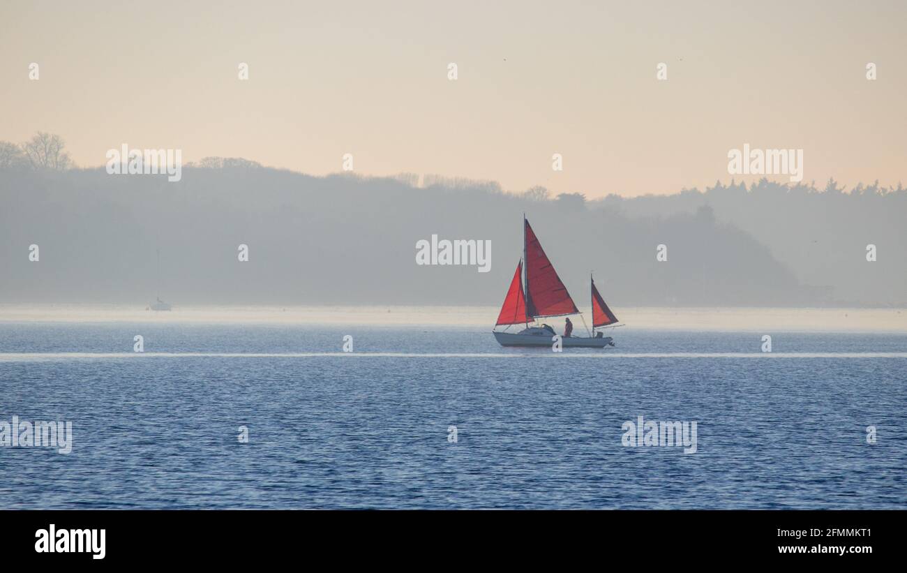 Boat with Red Sails on the River Stock Photo - Alamy