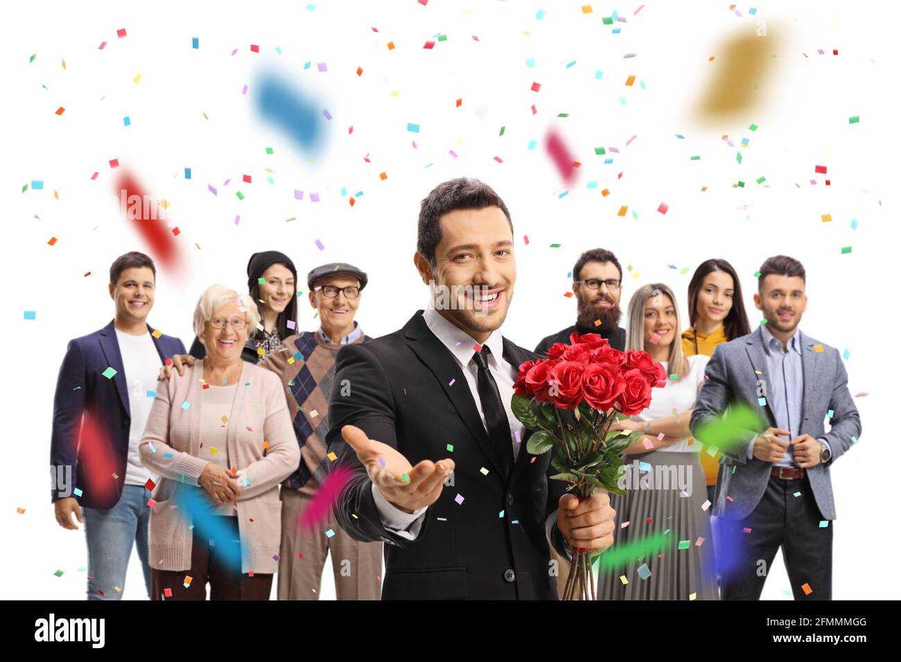 Young man holding roses and celebrating with people behind isolated on ...