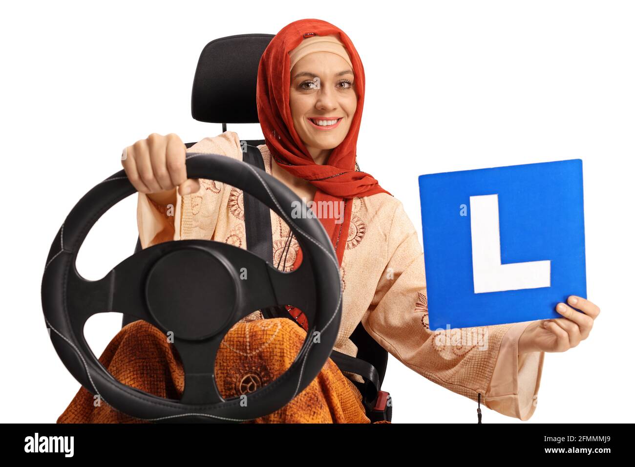 Young muslim woman in a car seat holding a learner plate isolated on ...
