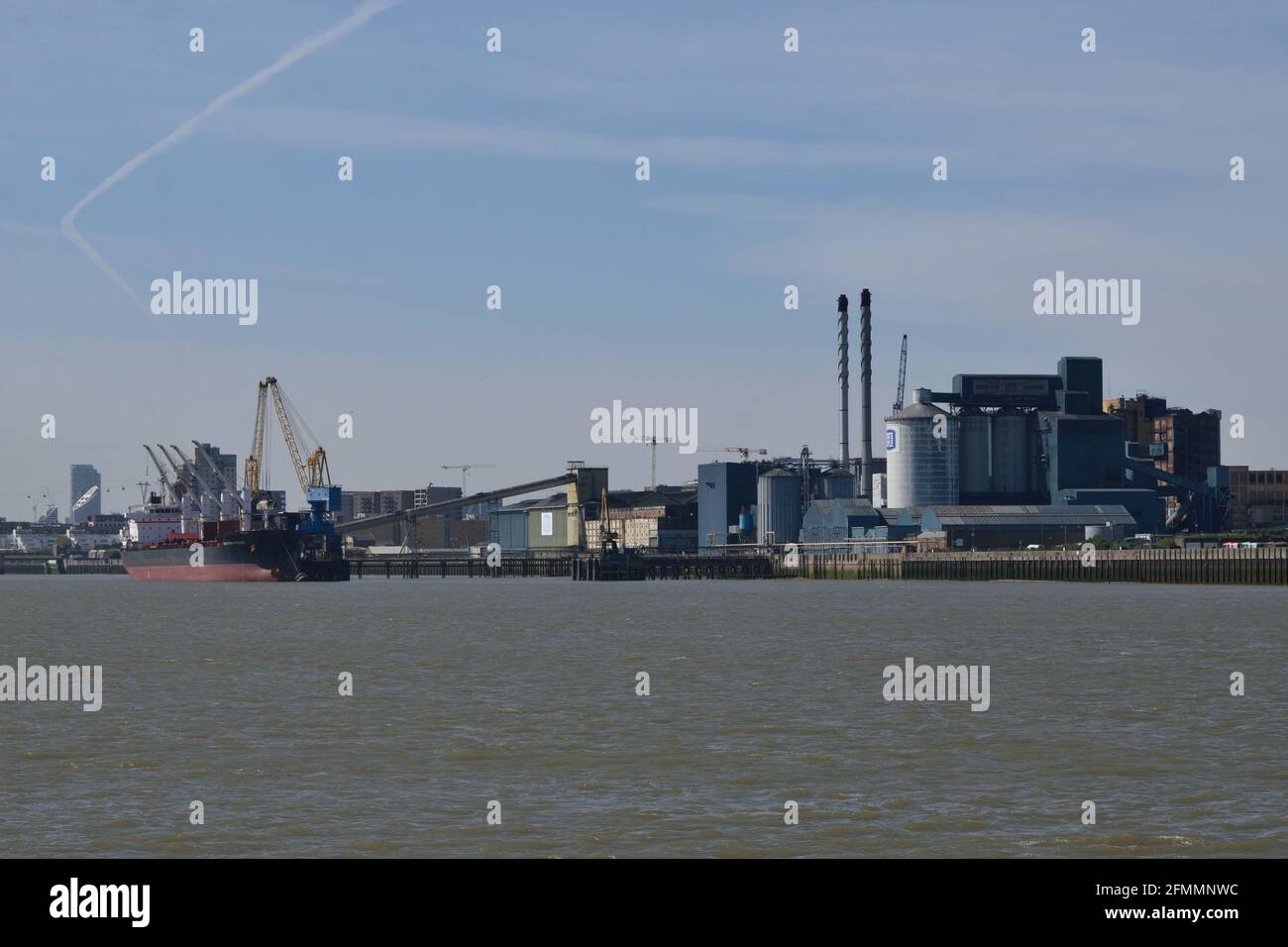 View of cargo ship unloading at Tate & Lyle's Thames Refinery Wharf and ...