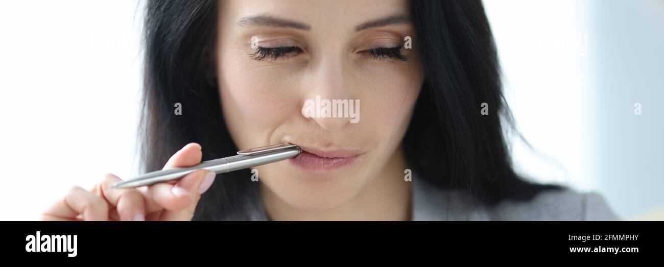 Woman with sly eyes looks at diary Stock Photo - Alamy