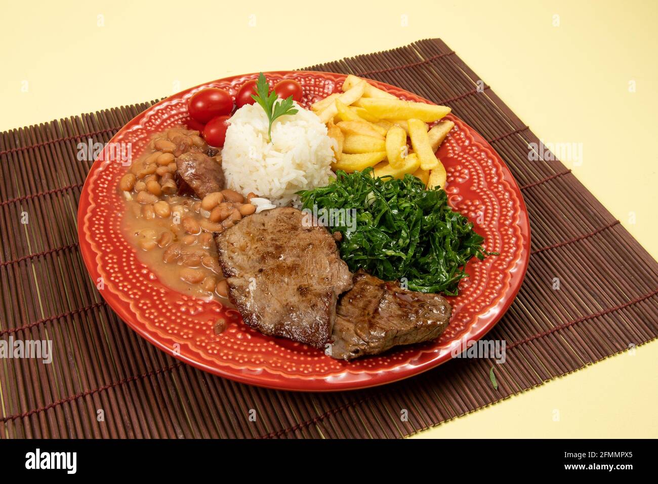 typical Brazilian basic dish with rice, beans, steak, french fries ...