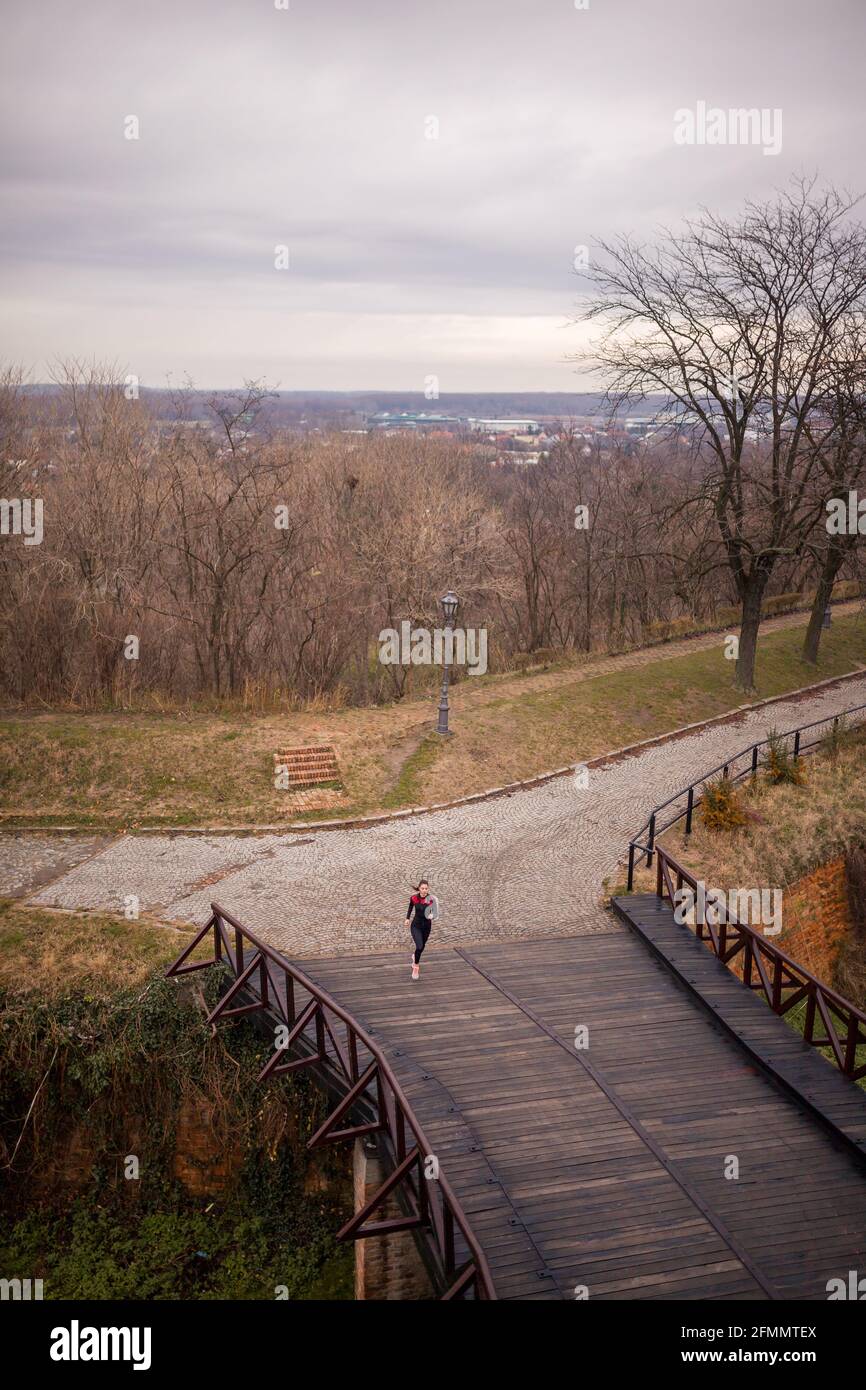 landscape, one young woman running, jogging outdoors Stock Photo - Alamy