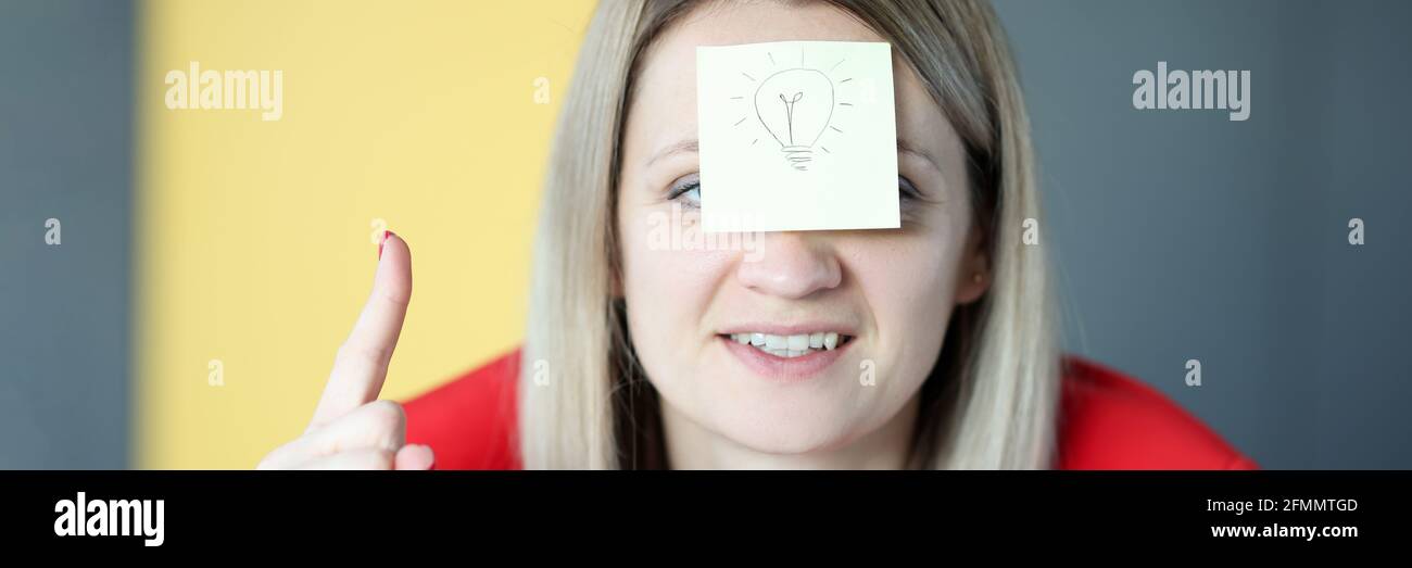 Business woman has sticker with painted light bulb on her face Stock ...
