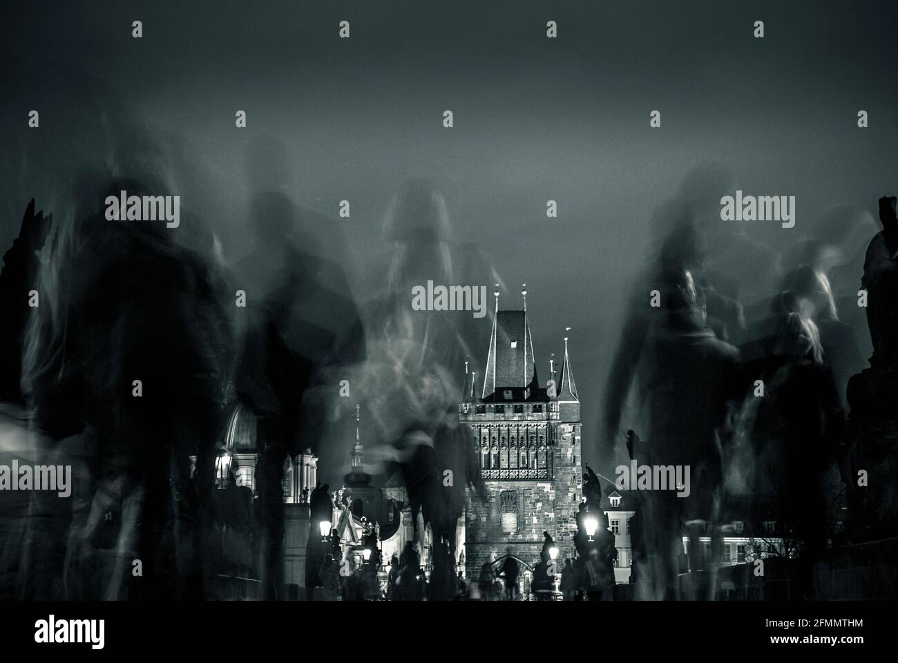 Pedestrian walking on Charles Bridge in Prague at night Stock Photo - Alamy
