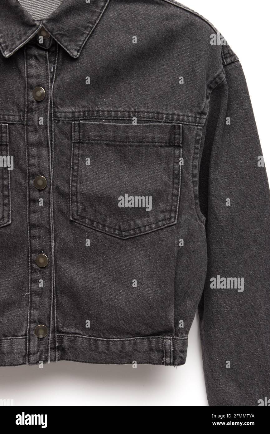 Black denim jacket for background. Close up of the front of a denim ...