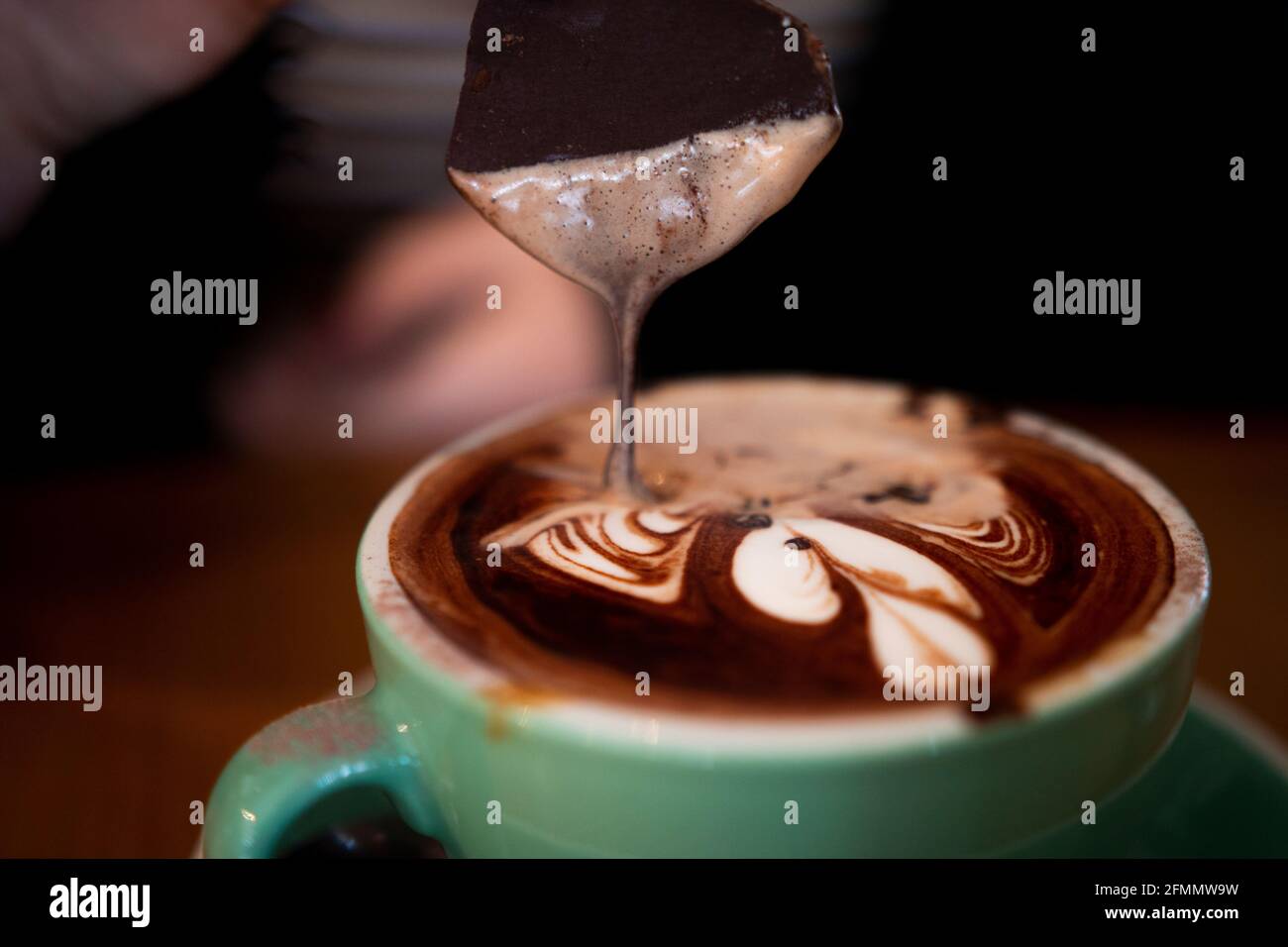 Melting Chocolate Drips into Mocha Coffee Stock Photo - Alamy
