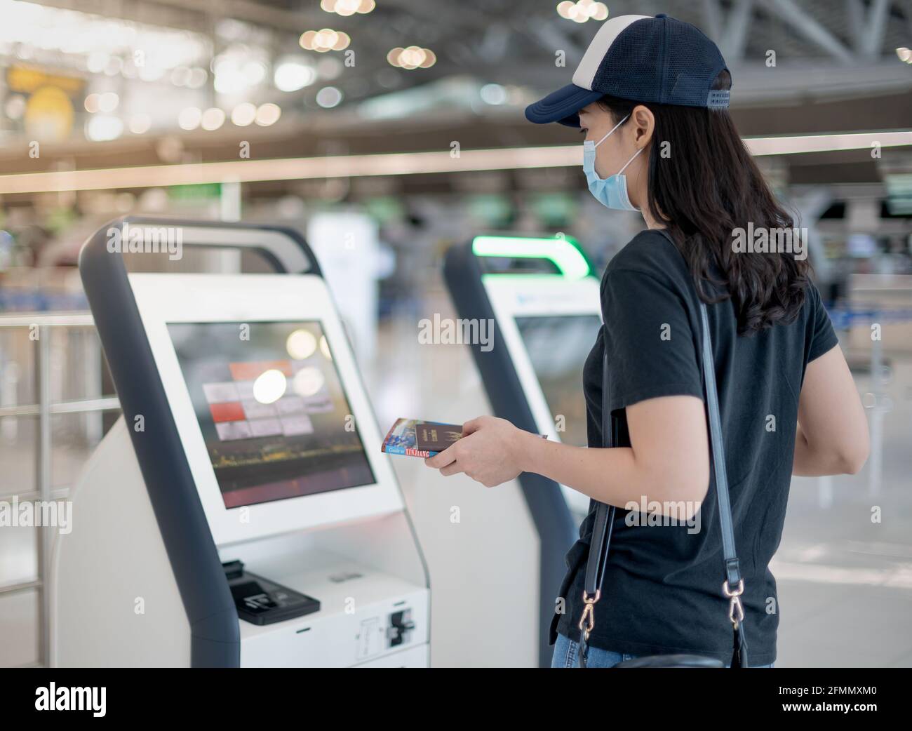 Female hand using the auto self service check-in for get the boarding ...