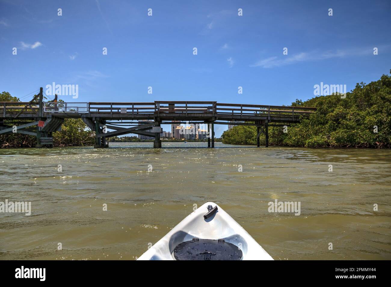 Bridge leading to the ocean of Clam Pass from a kayak in Naples ...