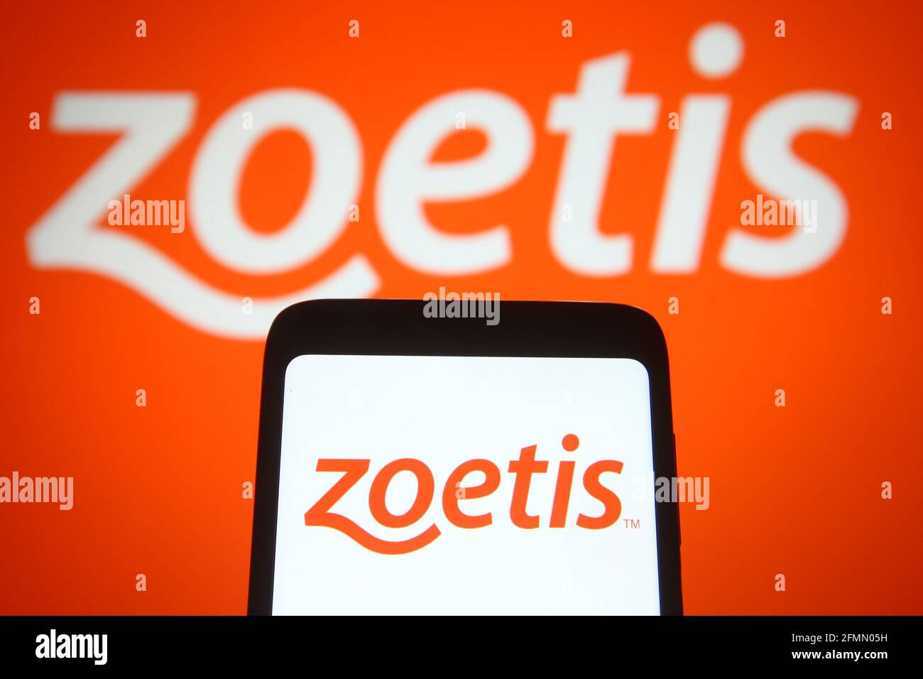 In this photo illustration the Zoetis logo is seen on a smartphone and ...