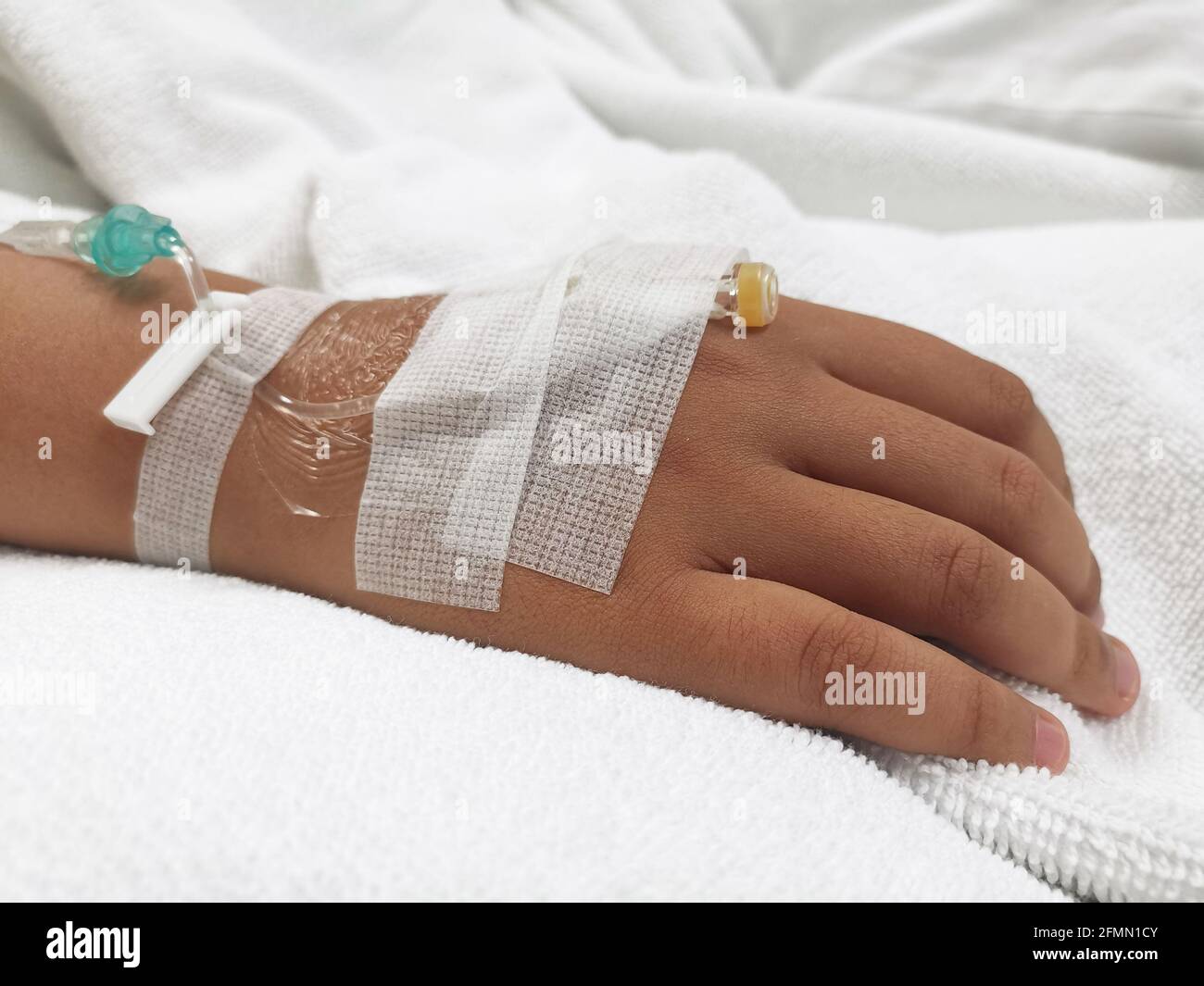 Closeup kid hand with saline intravenous Stock Photo - Alamy