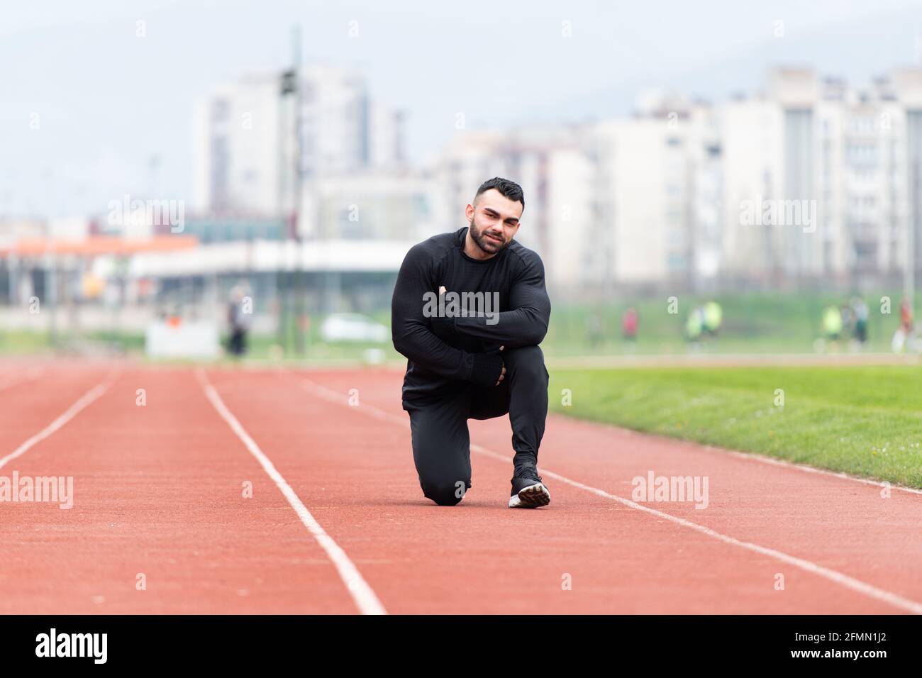 Young Athlete Man Relax and Strech Ready for Run at Athletics Race ...