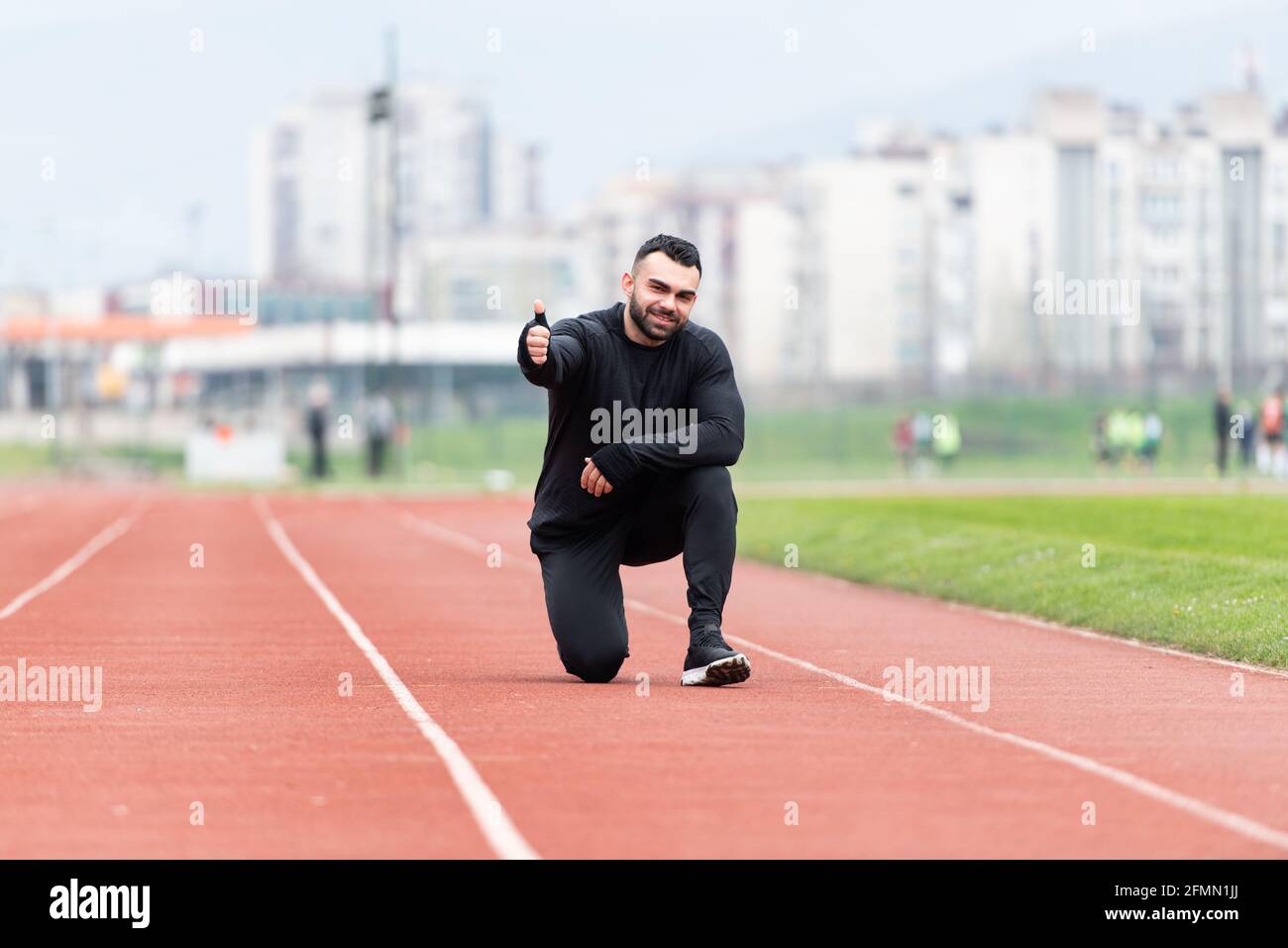Young Athlete Man Relax and Strech Ready for Run at Athletics Race ...