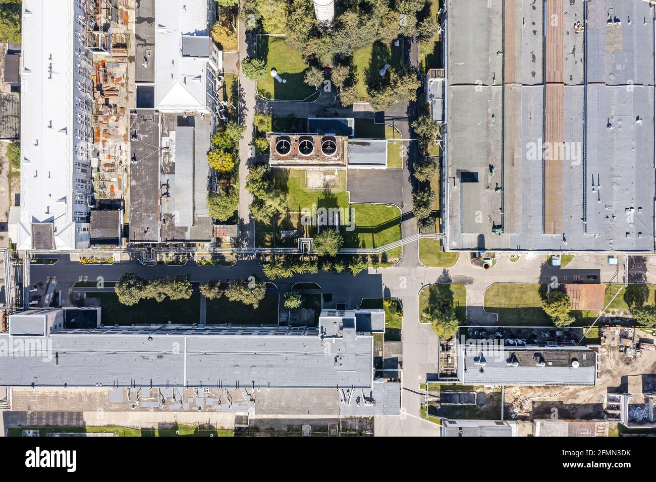 aerial top view of roofs of industrial buildings and factories at urban ...