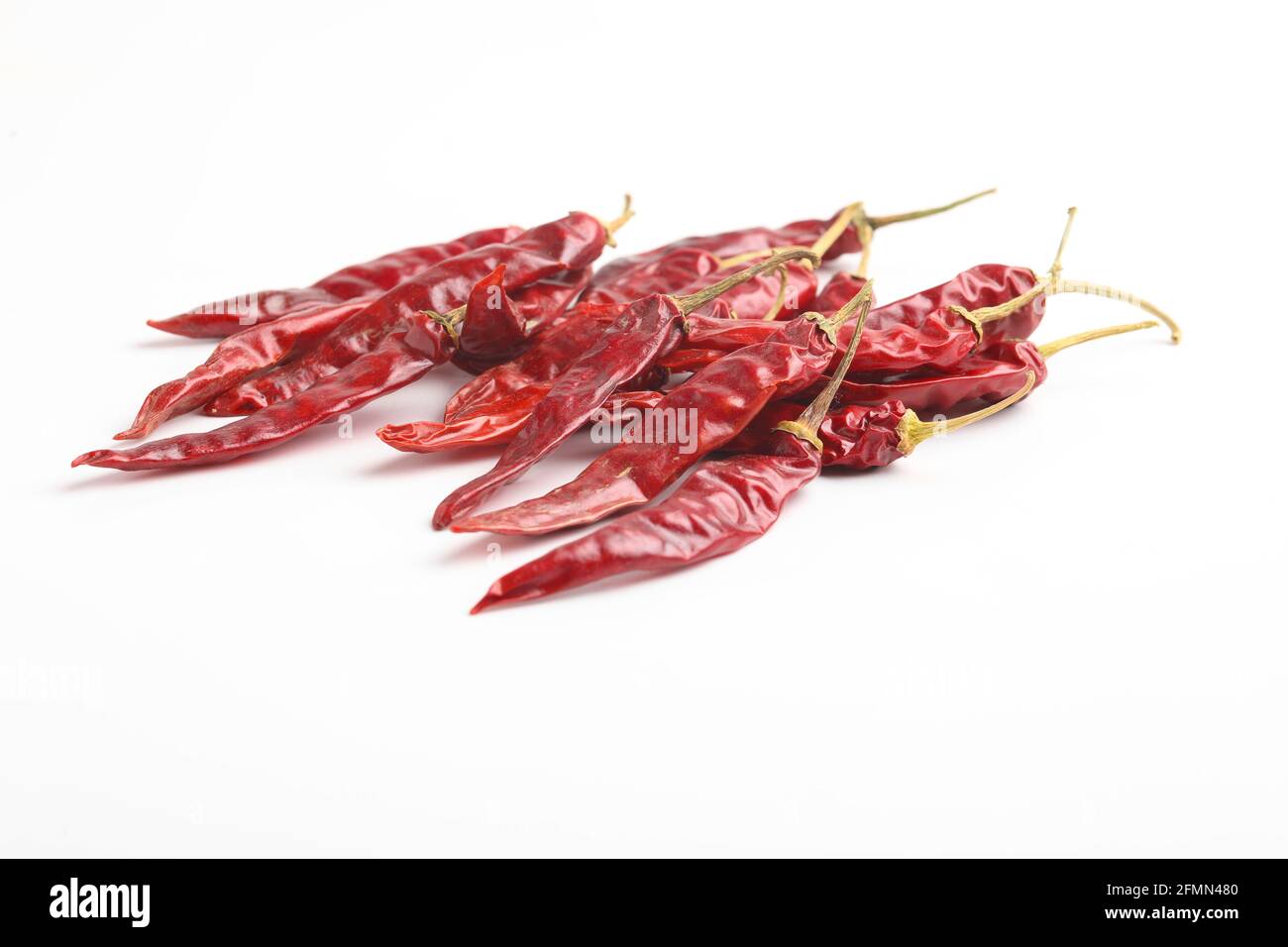 Dried red chilli on white background Stock Photo - Alamy