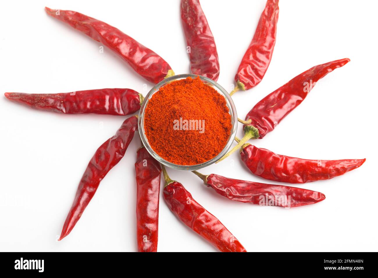 Dried red chilli and powder in glass bowl on white background Stock ...