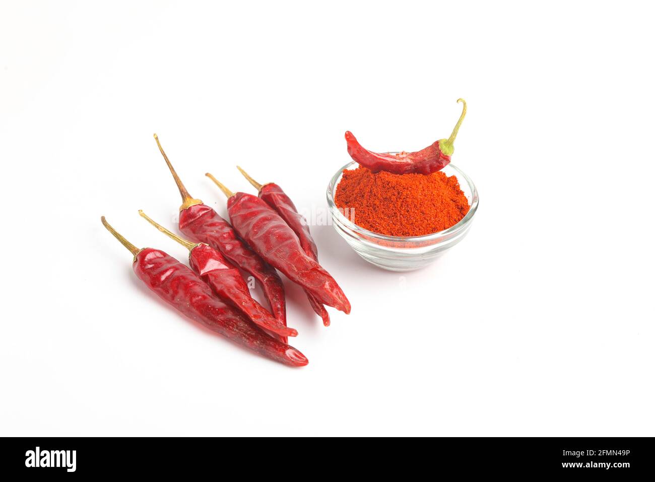 Dried red chilli and powder in glass bowl on white background Stock ...