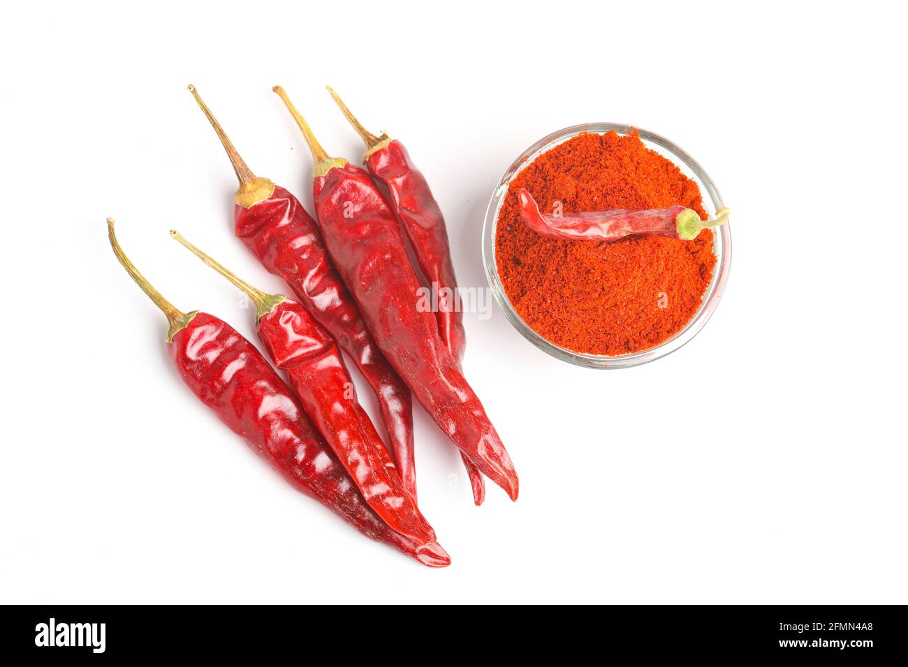 Dried red chilli and powder in glass bowl on white background Stock ...