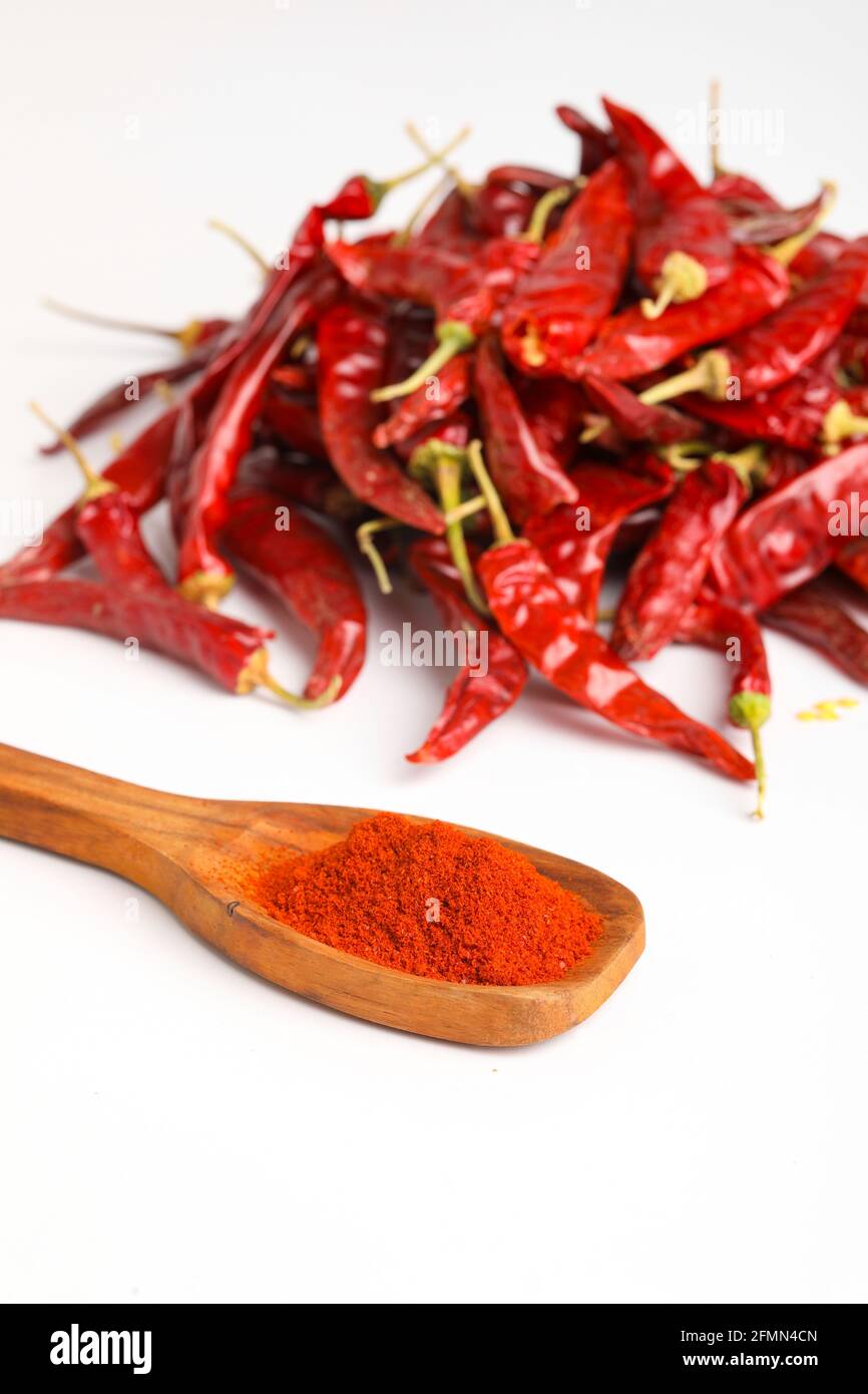 Dried red chilli and powder in wooden spoon on white background Stock ...