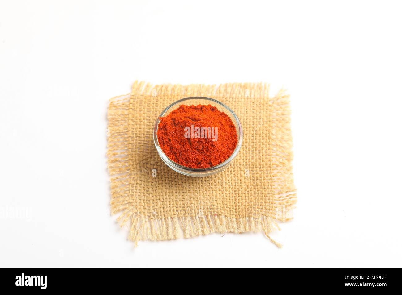 Red chilli powder in glass bowl on white background Stock Photo - Alamy