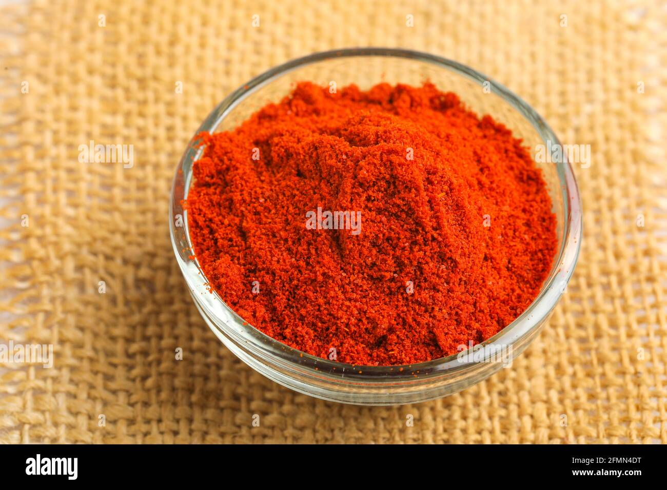 Red chilli powder in glass bowl on white background Stock Photo - Alamy