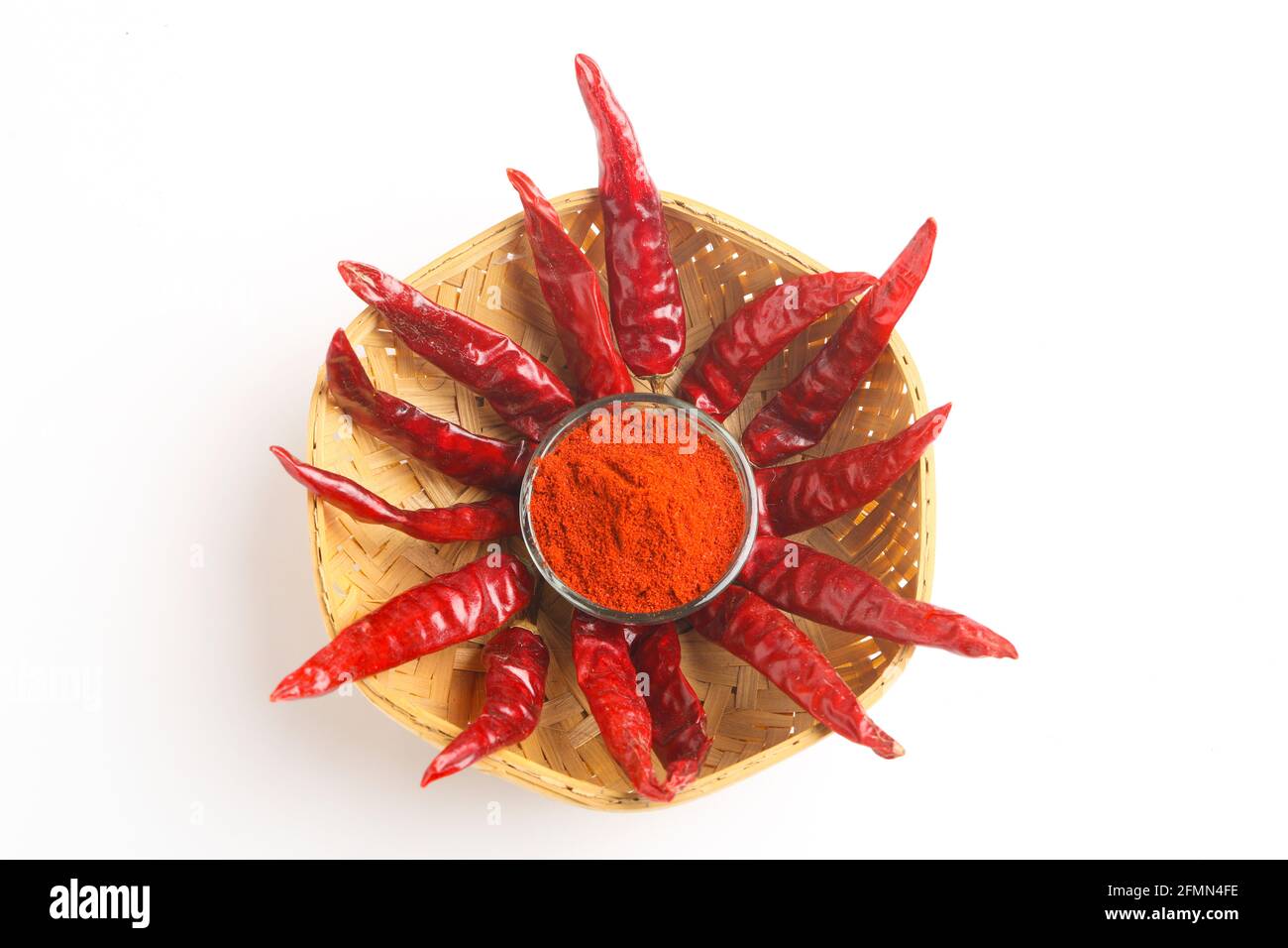 Dried red chilli and red chilli powder in glass bowl and wooden spoon ...