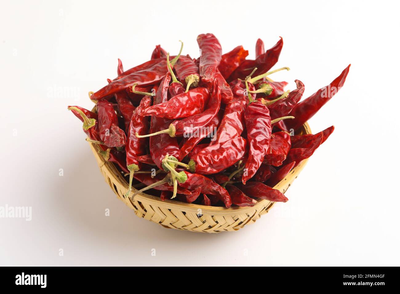 Dried red chilli and red chilli powder in glass bowl and wooden spoon ...