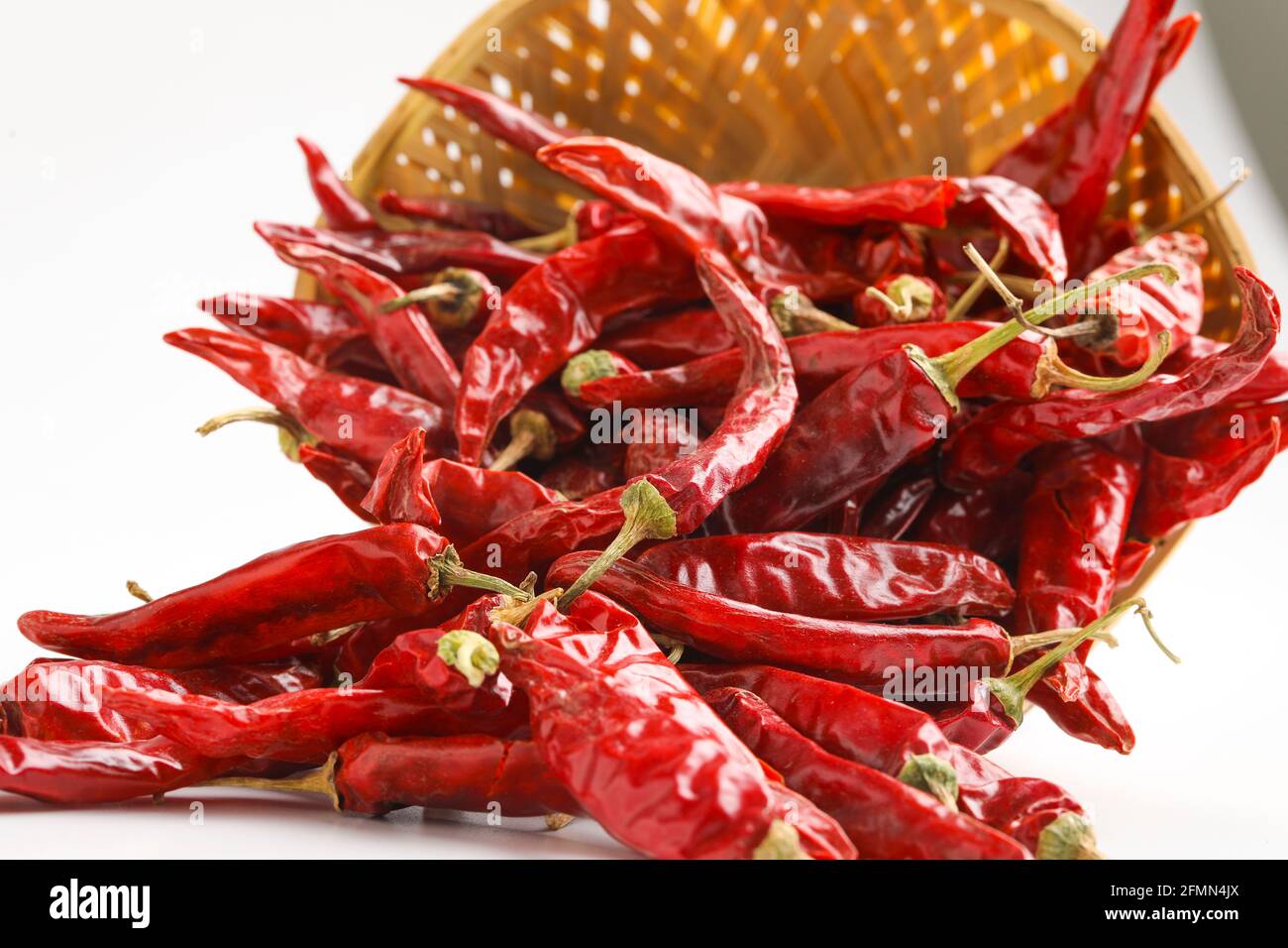 Dried red chilli wooden bowl on white background Stock Photo - Alamy