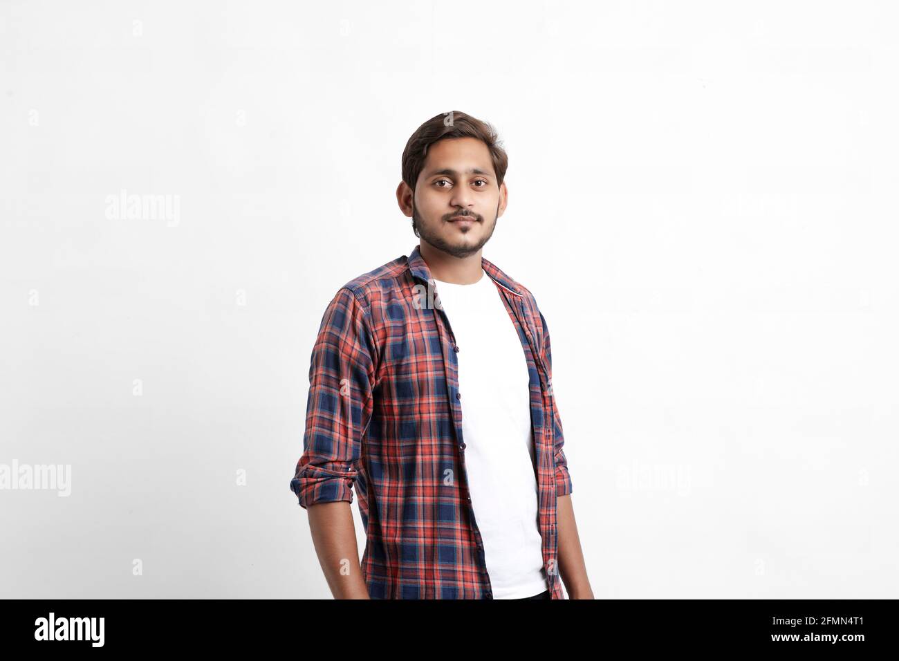 Indian or Asian man giving multi pal expression over white background ...
