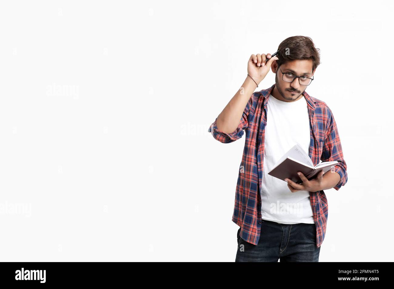 Young handsome indian college student giving thinking expression on ...