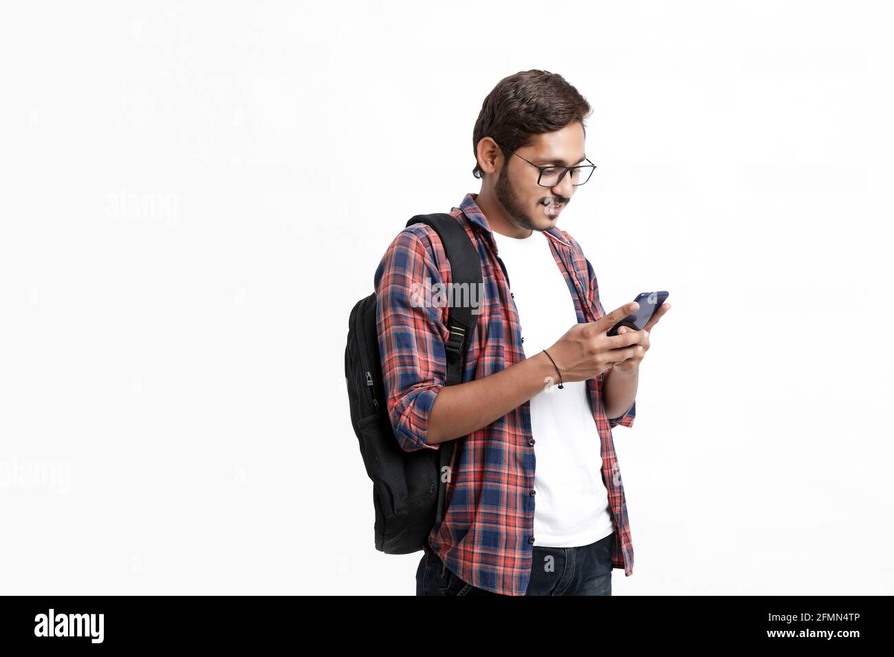 Indian college student using smartphone on white background Stock Photo ...
