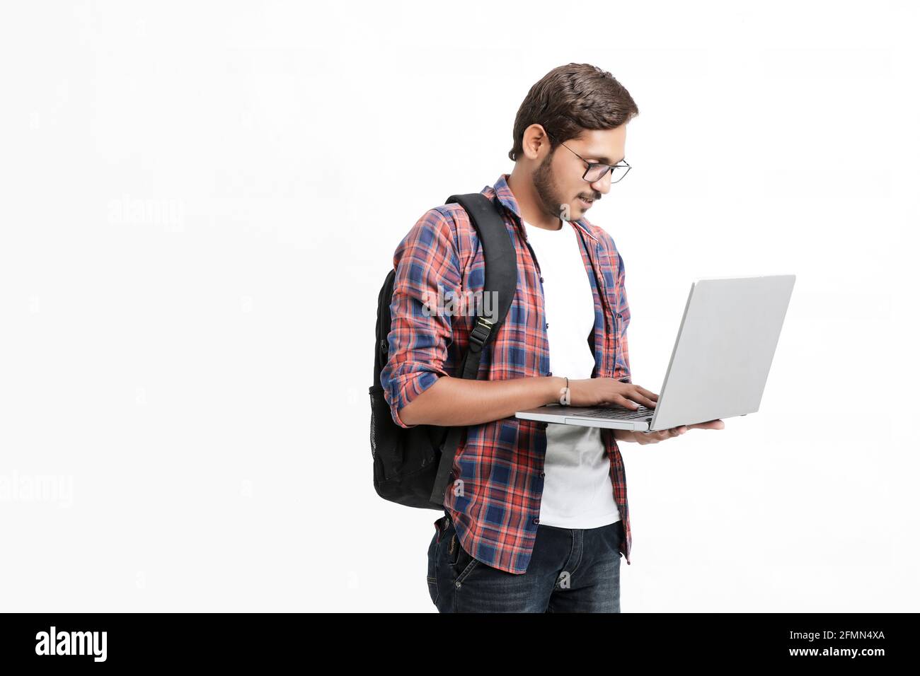 Indian college student using laptop on white background Stock Photo - Alamy