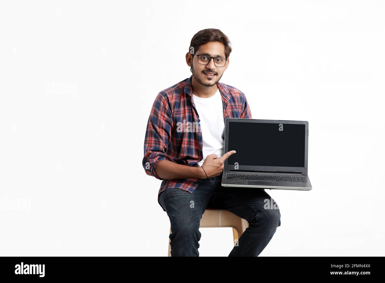 Indian college student showing laptop screen on white background Stock ...