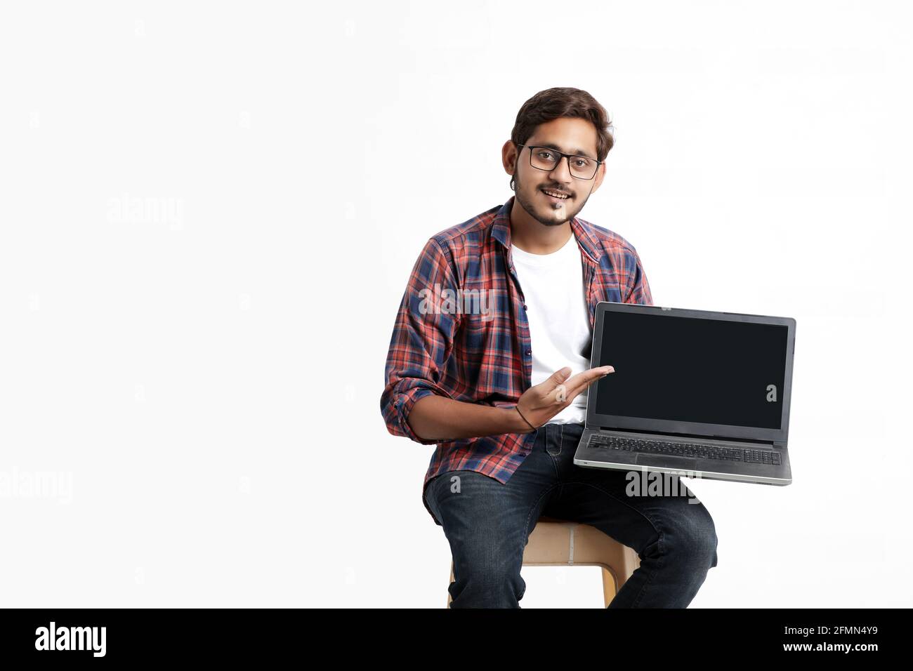 Indian college student showing laptop screen on white background Stock ...