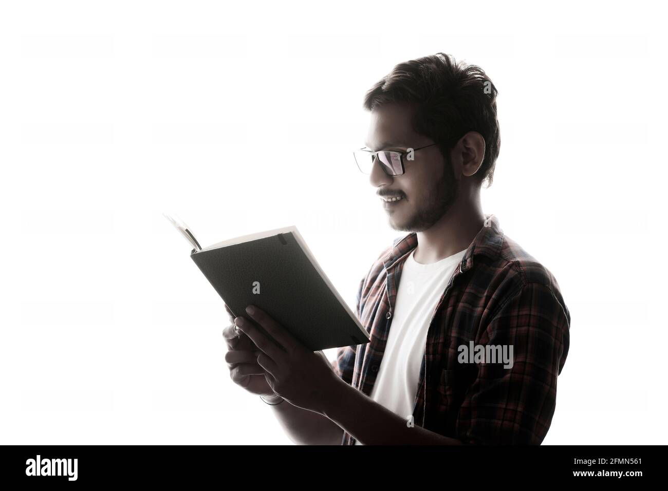 Indian college student reading book on white background Stock Photo - Alamy