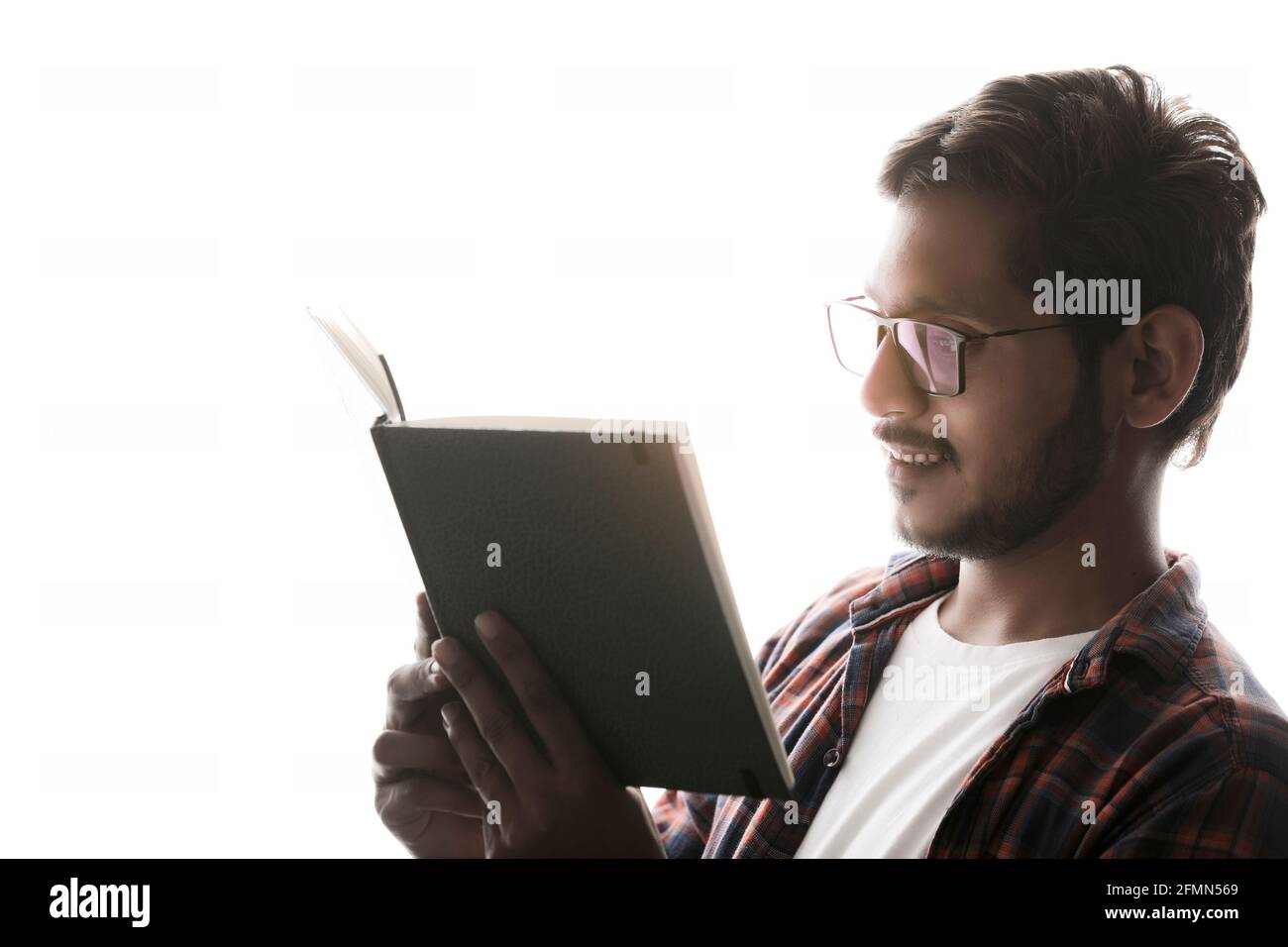 Indian college student reading book on white background Stock Photo - Alamy