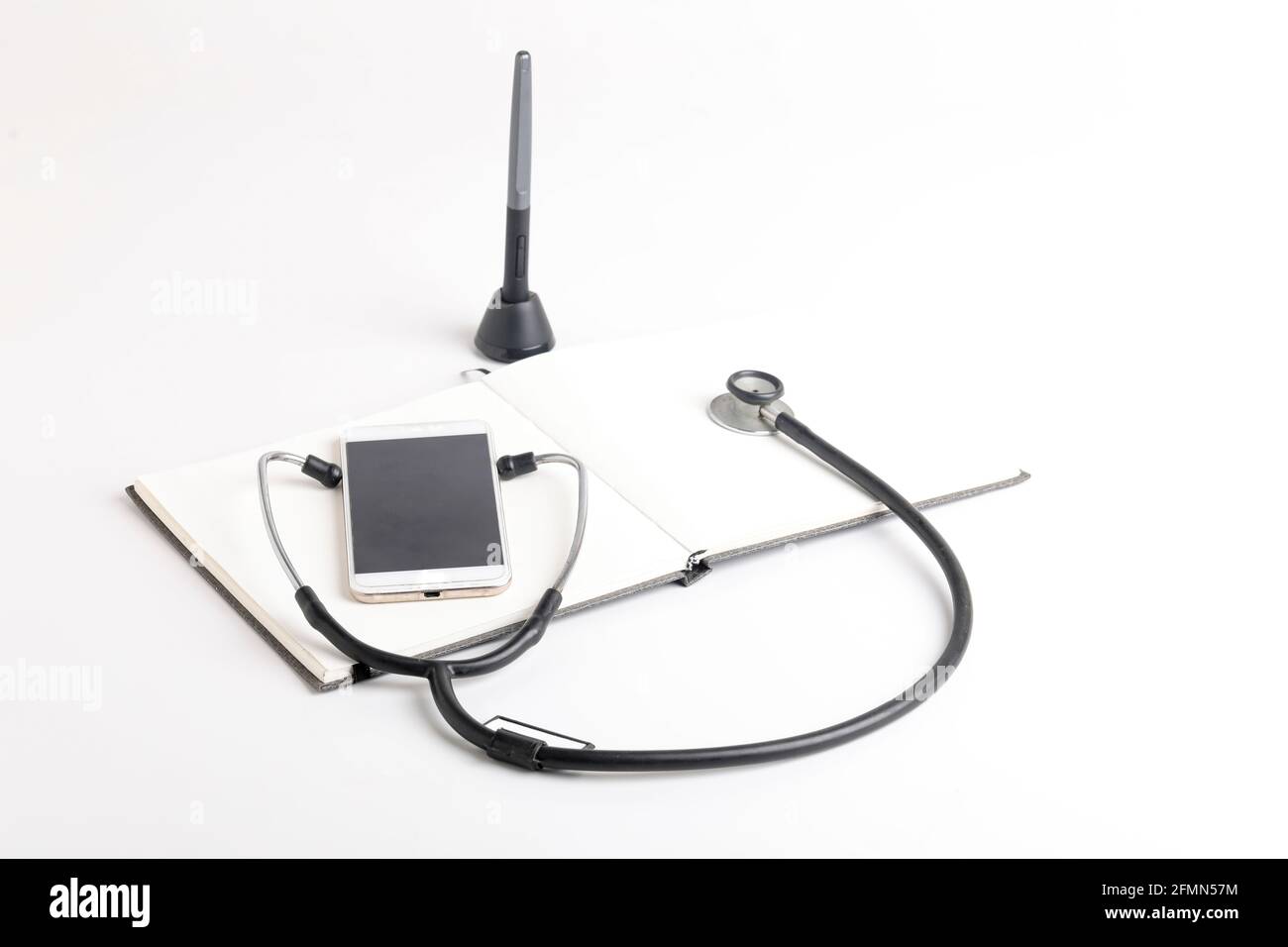 Smartphone and stethoscope on white background. Online medicine ...