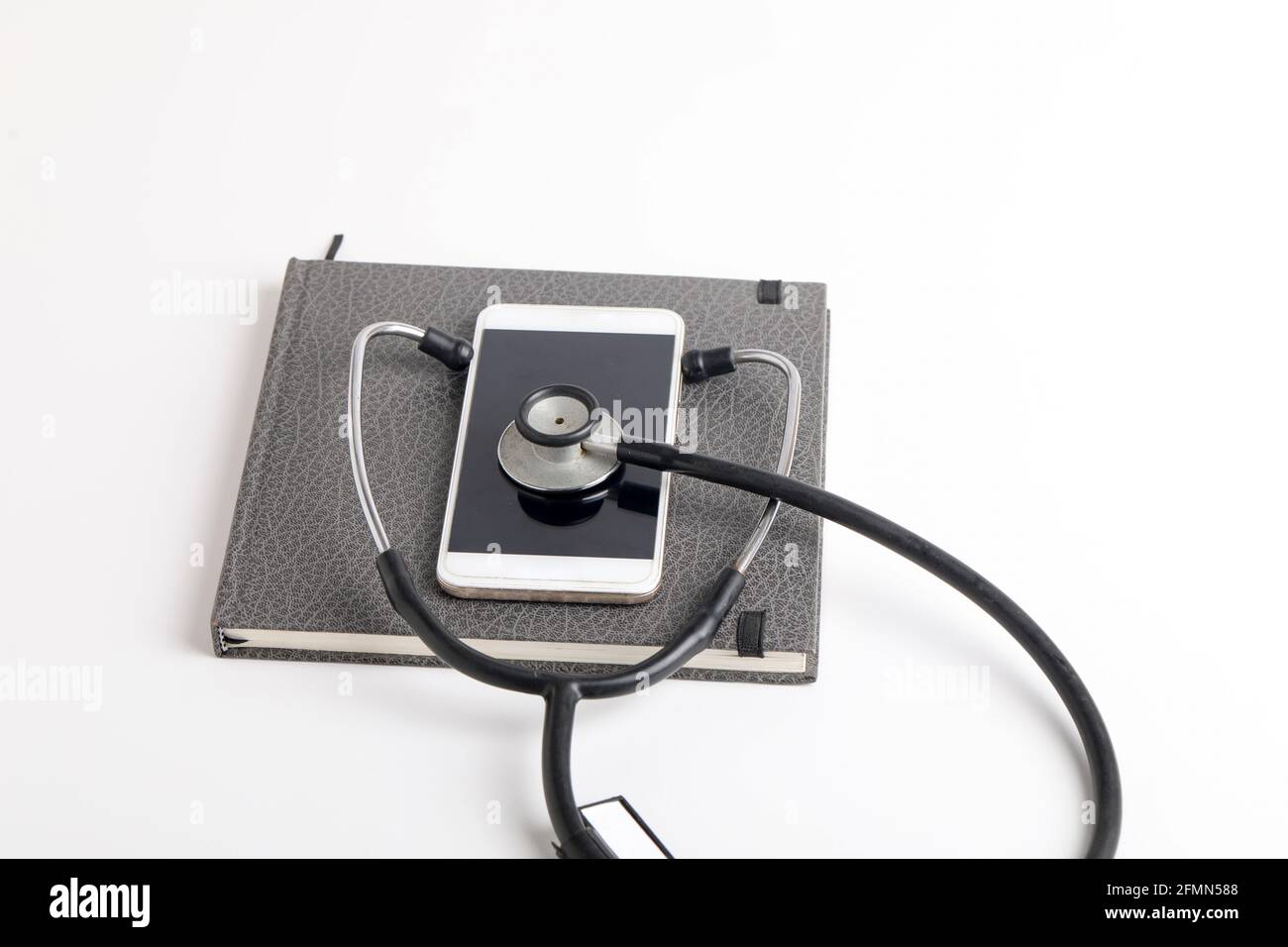 Smartphone and stethoscope on white background. Online medicine ...