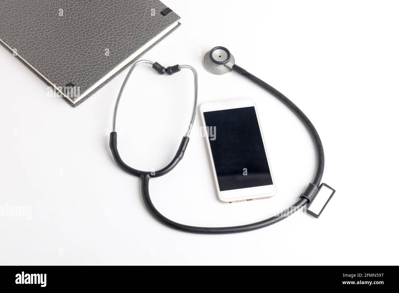 Smartphone and stethoscope on white background. Online medicine ...
