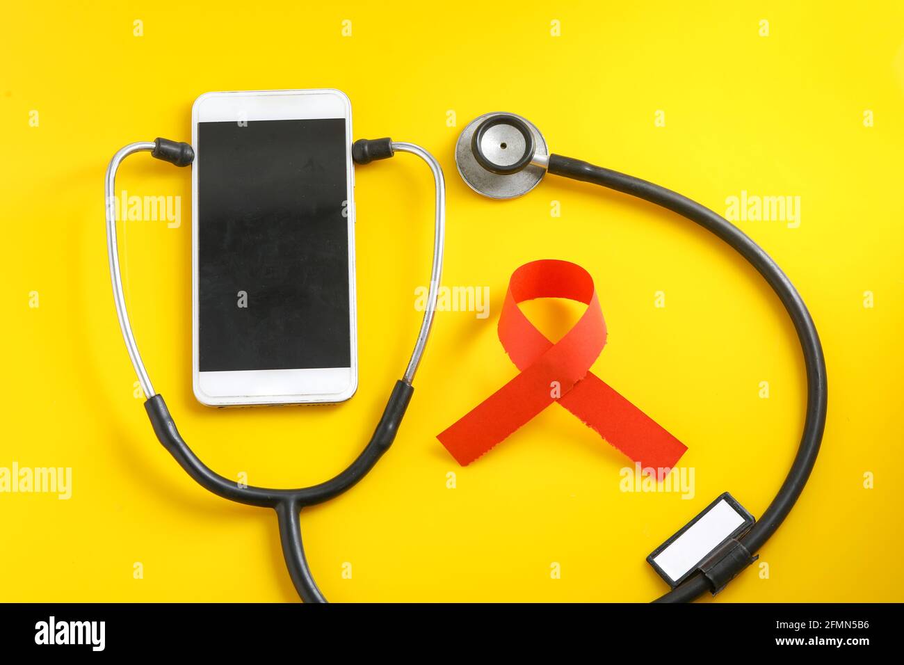 Smartphone and stethoscope on yellow background. Online medicine ...
