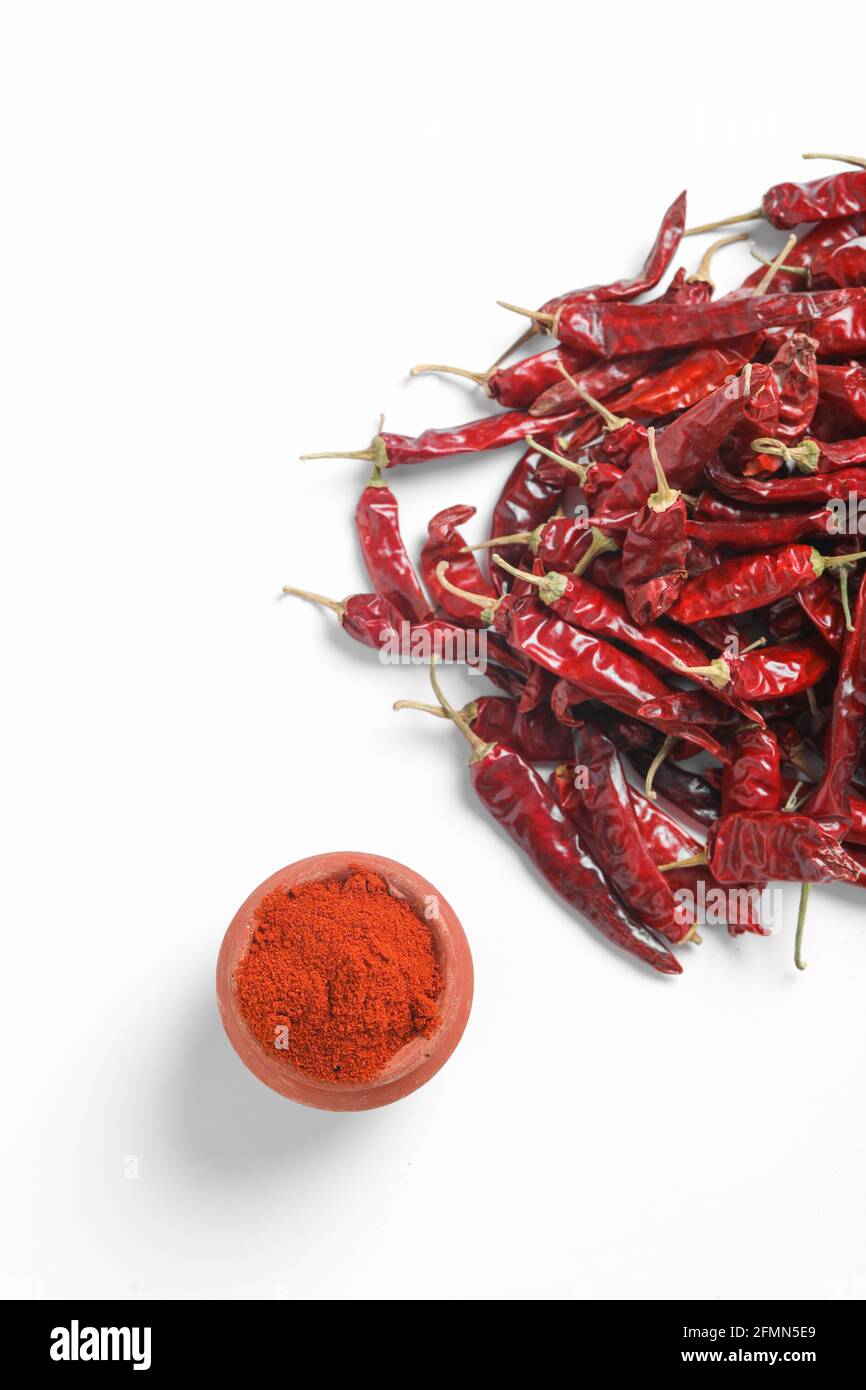 Red chilli powder with dried red chillies. in earthen bowl Stock Photo ...