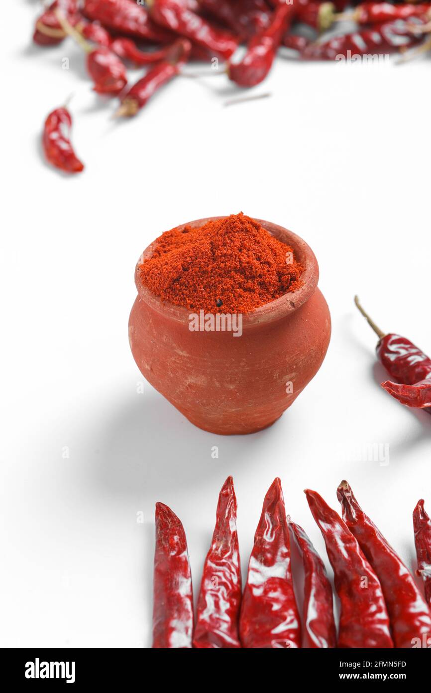 Red chilli powder with dried red chillies. in earthen bowl Stock Photo ...