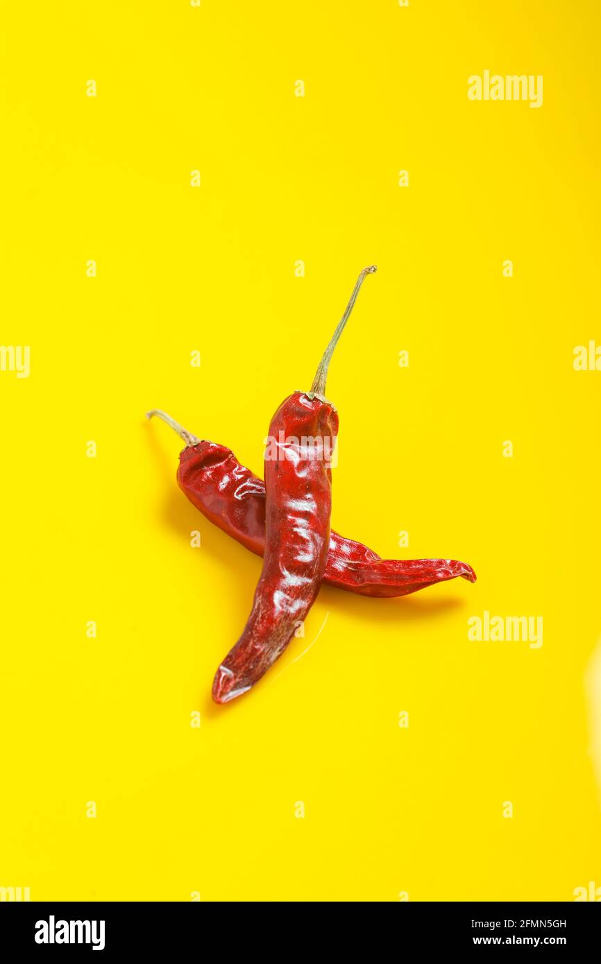 Dry Red chilli on yellow background Stock Photo - Alamy