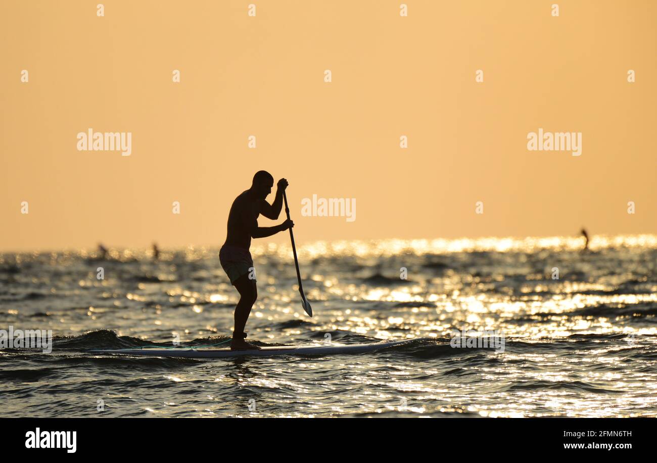 A man paddle boarding by the beach in Tel-Aviv Stock Photo - Alamy
