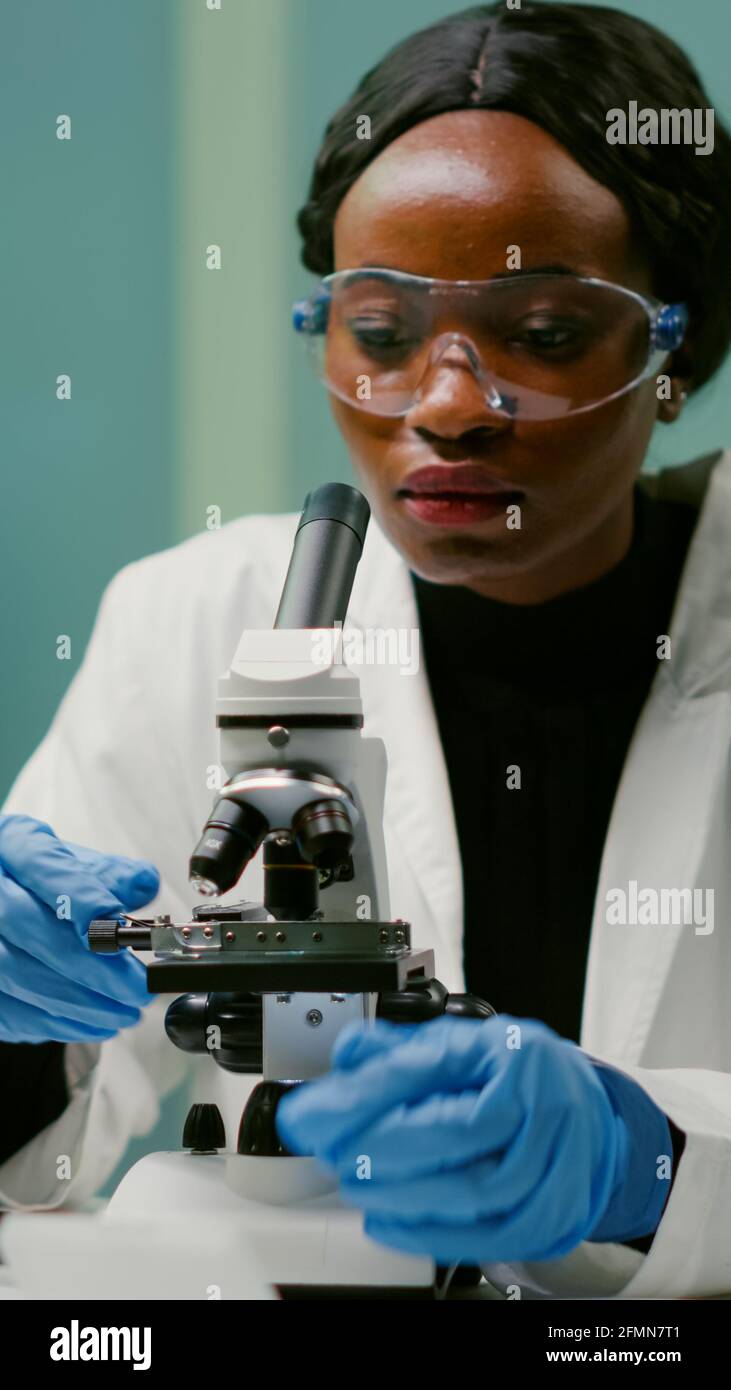 Scientist putting liquid under microscope hi-res stock photography and ...